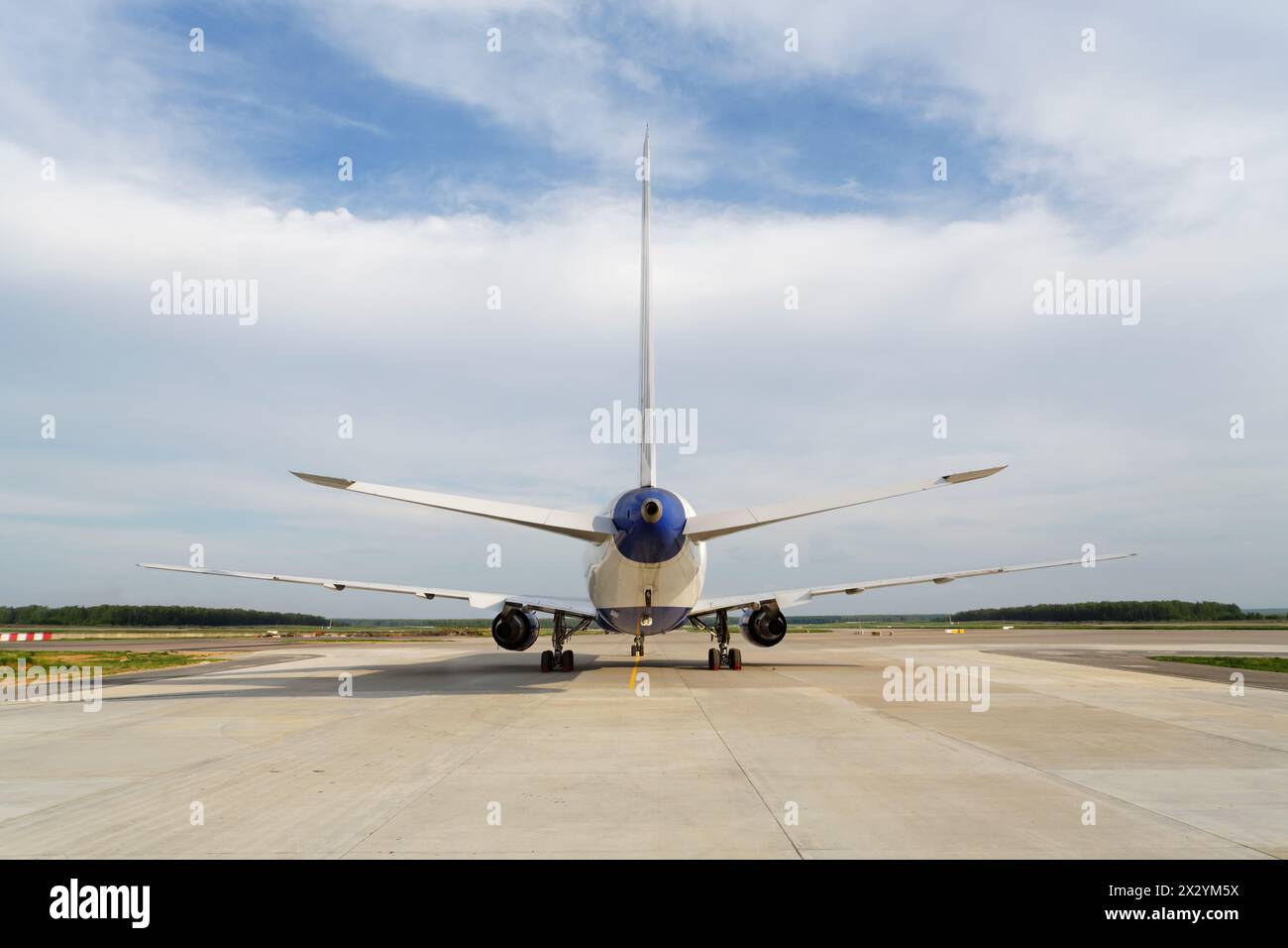 Back view of airplane standing on runway at aerodrome Stock Photo - Alamy