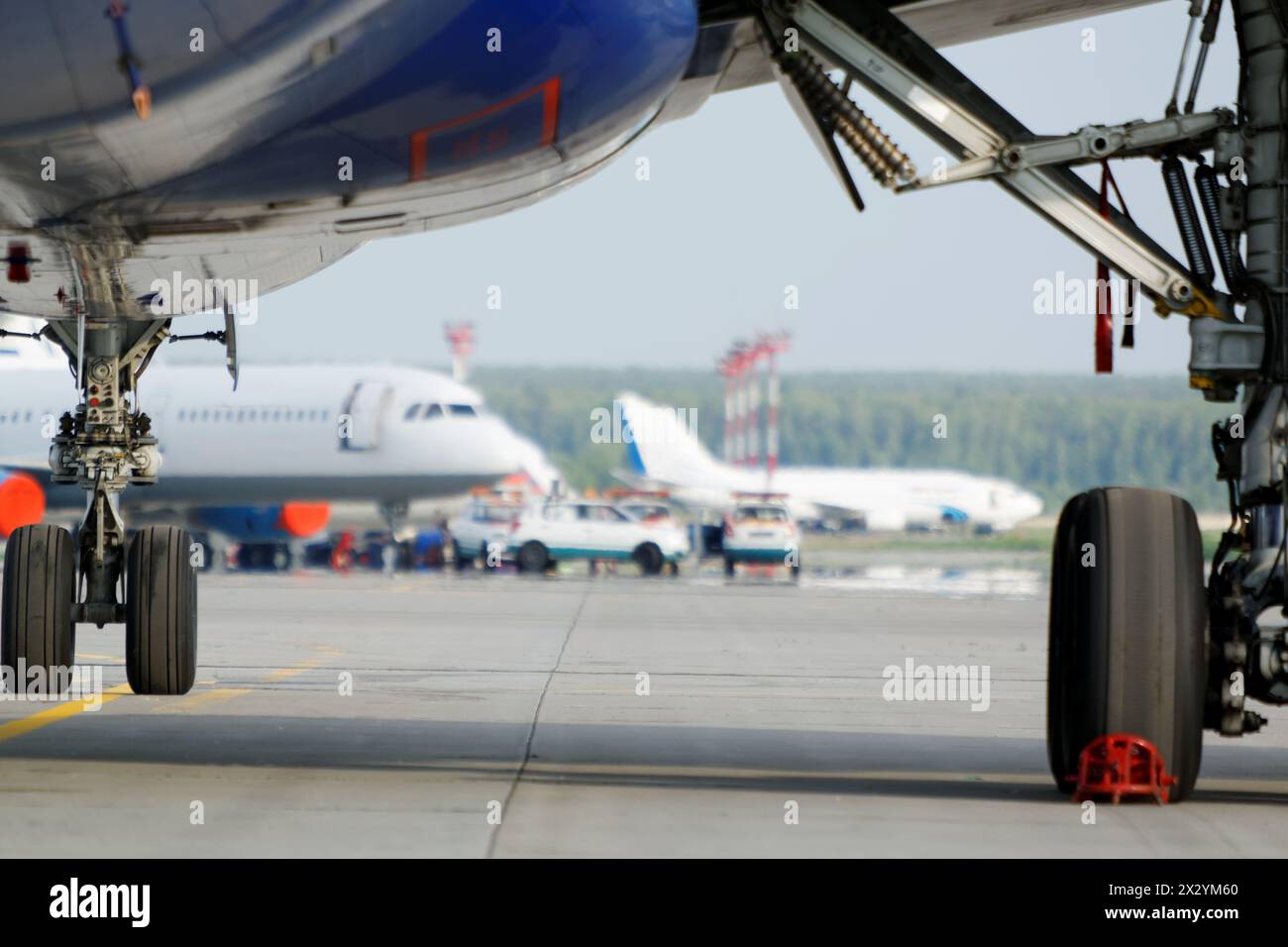 View at airfield from under wing of plane standing on parking Stock ...