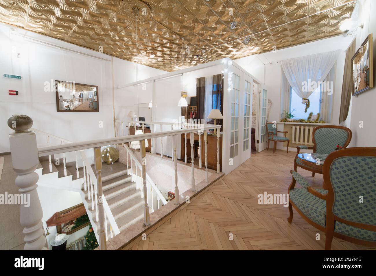 The interior corridor with chairs, staircase and parquet flooring Stock ...