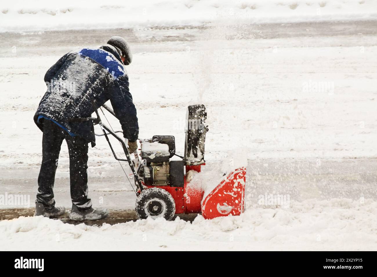 Man removes snow ice hi-res stock photography and images - Alamy