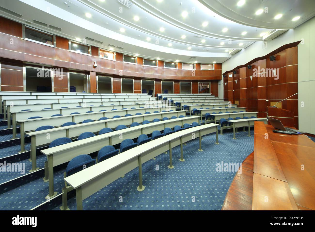 MOSCOW - AUGUST 18: Desks and blue seats in empty university auditorium ...