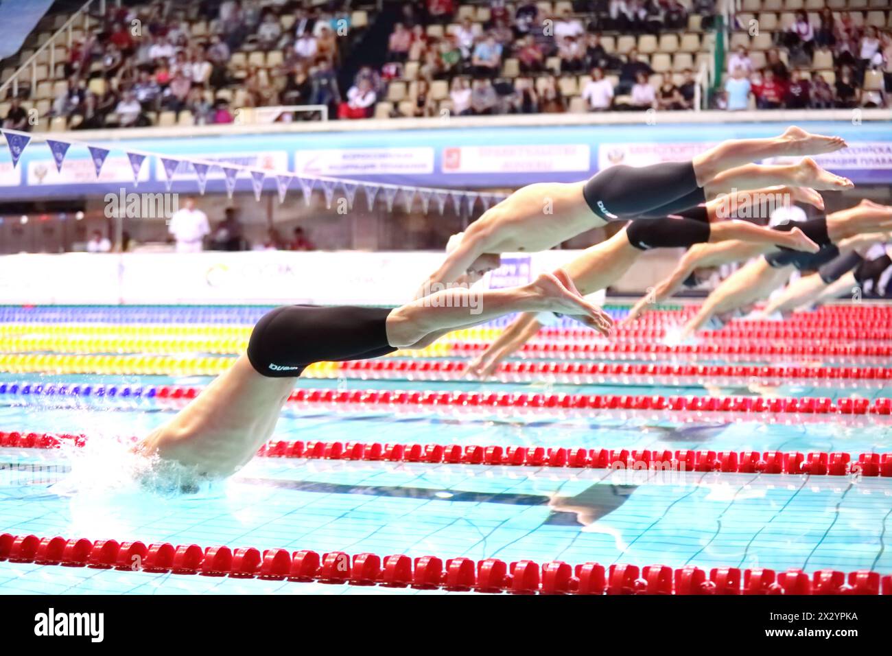 MOSCOW - APR 20: Group swimmers jumping into the water in the pool at ...