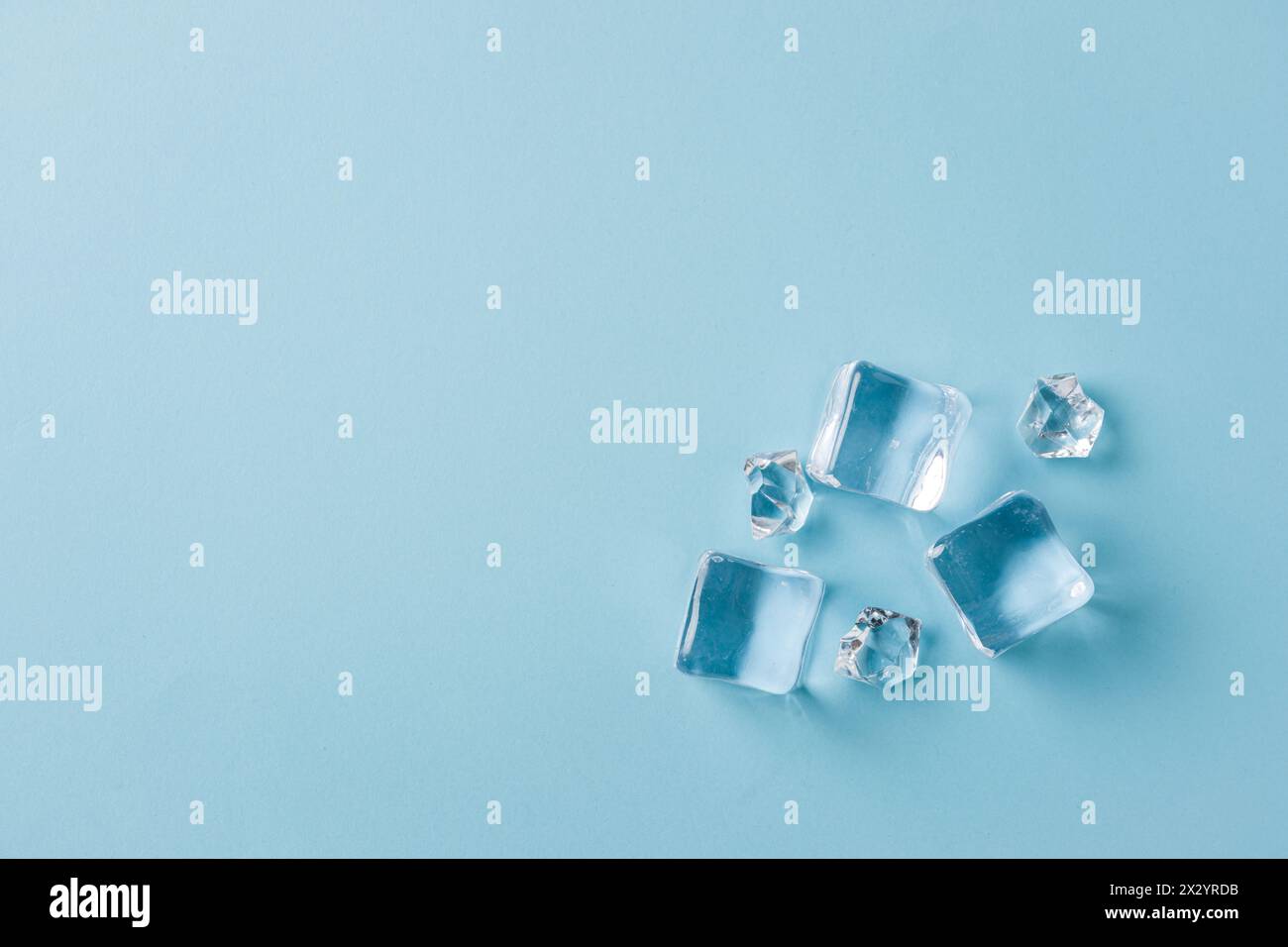 top view of ice cubes of different sizes on blue background Stock Photo ...
