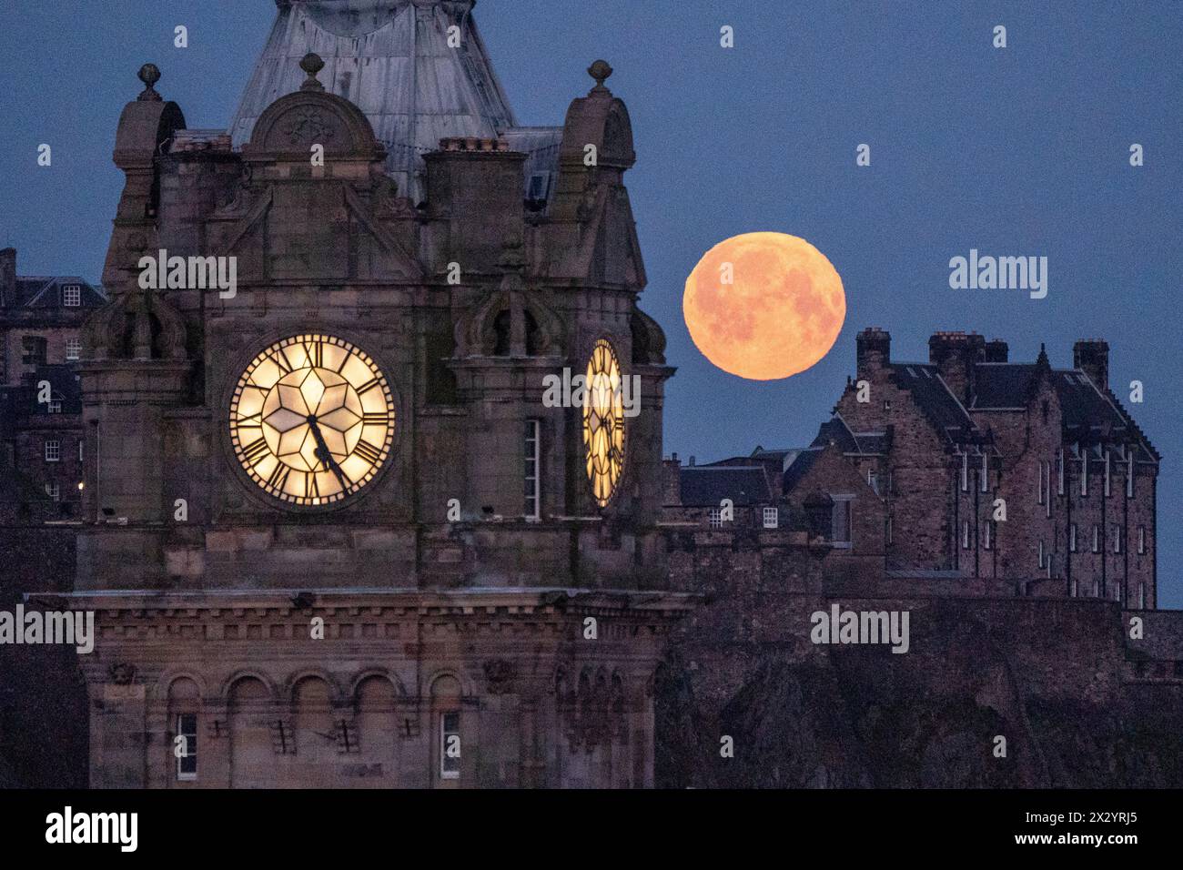 The full moon, which is known as the 'Pink Moon' during April, sets ...