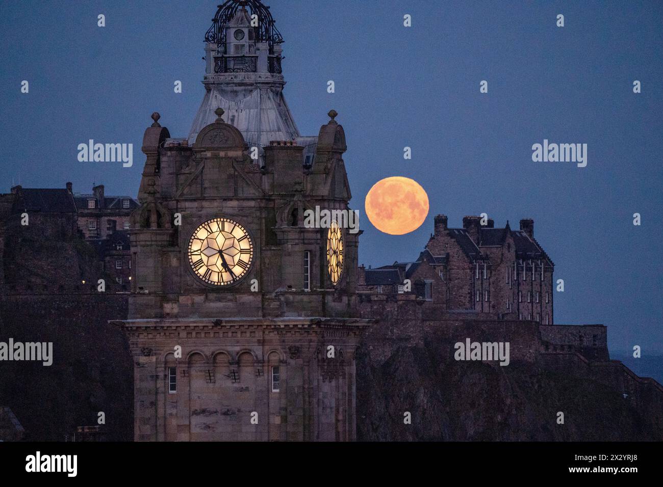 The full moon, which is known as the 'Pink Moon' during April, sets ...