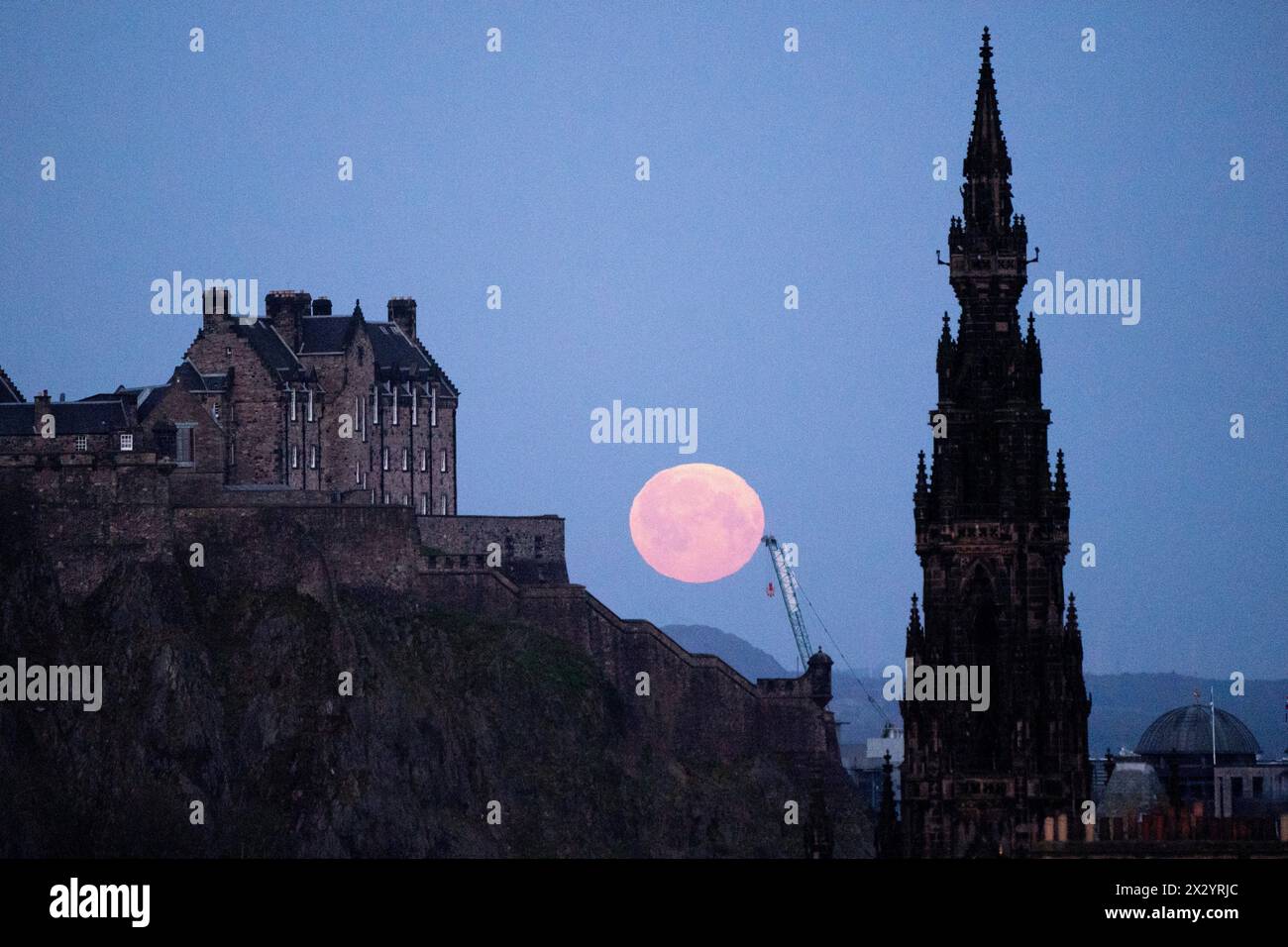 The full moon, which is known as the 'Pink Moon' during April, sets ...