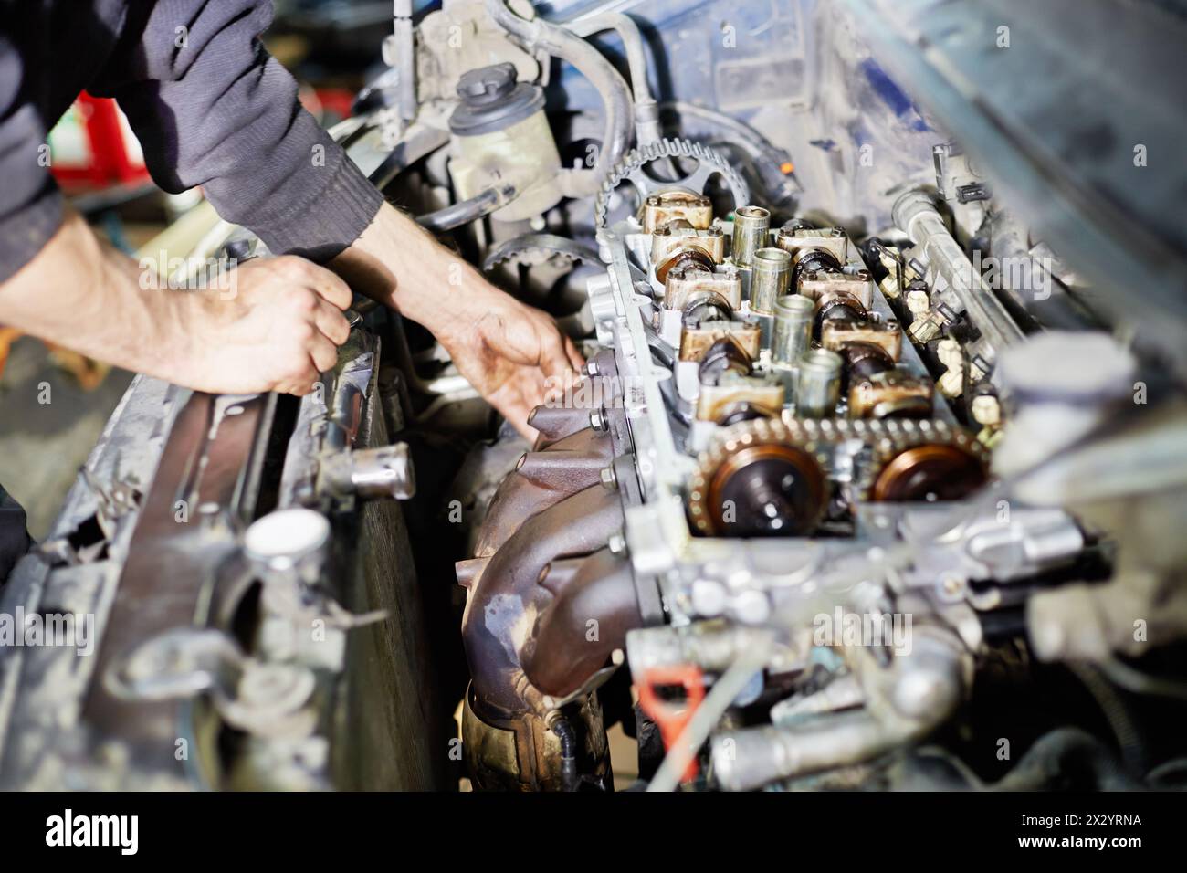 Hands of mechanic servicing car engine Stock Photo - Alamy