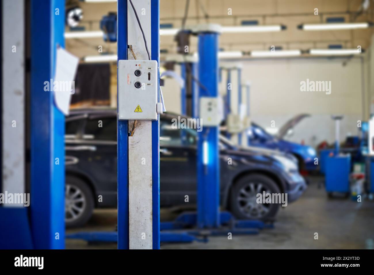 Remote control of electric lift in car-care service, shallow DOF Stock ...