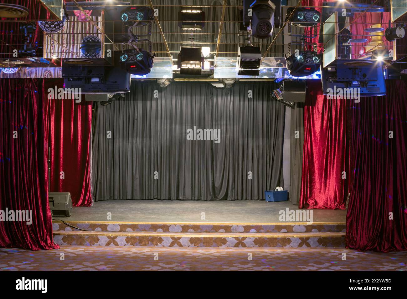 Small hall with a stage and a mirrored ceiling Stock Photo - Alamy