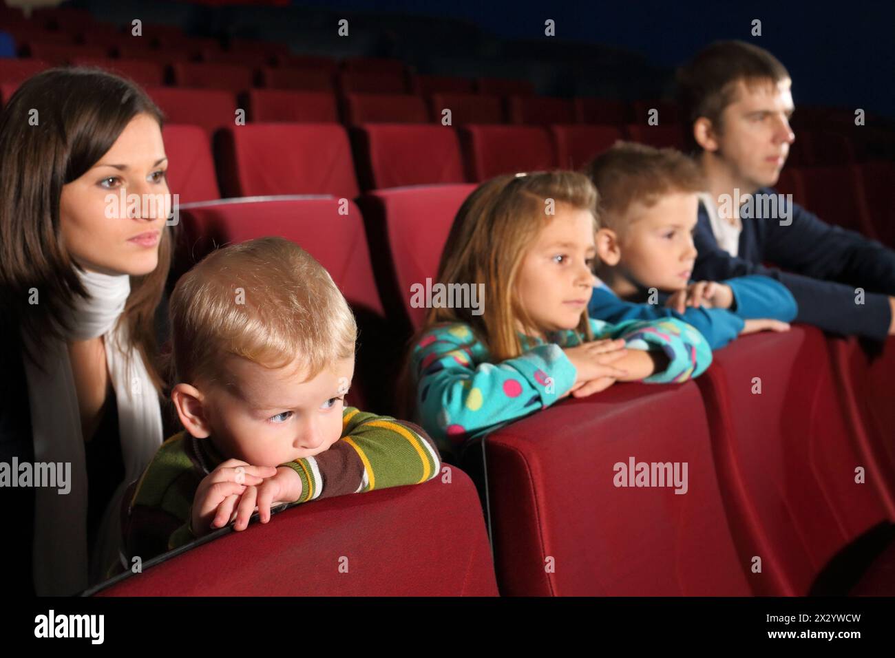 Young family of five people watching a movie Stock Photo - Alamy