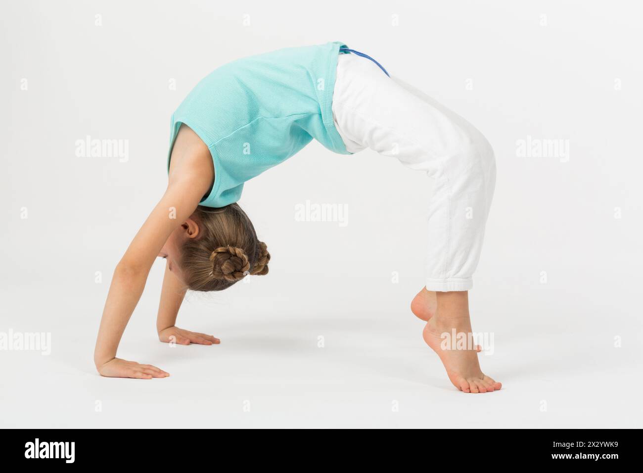 A girl in crab position makes gymnastic exercise Stock Photo - Alamy