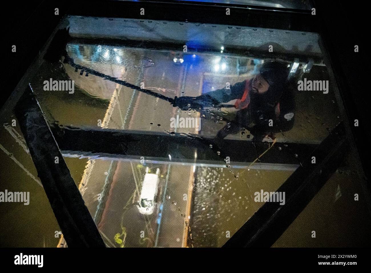 Rope access specialists hang from the underside of the walkways of ...