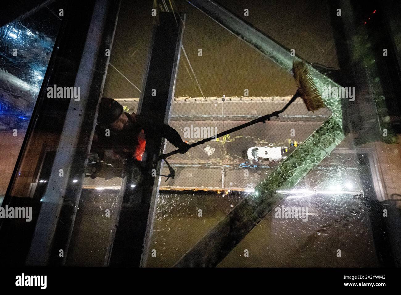 Rope access specialists hang from the underside of the walkways of ...