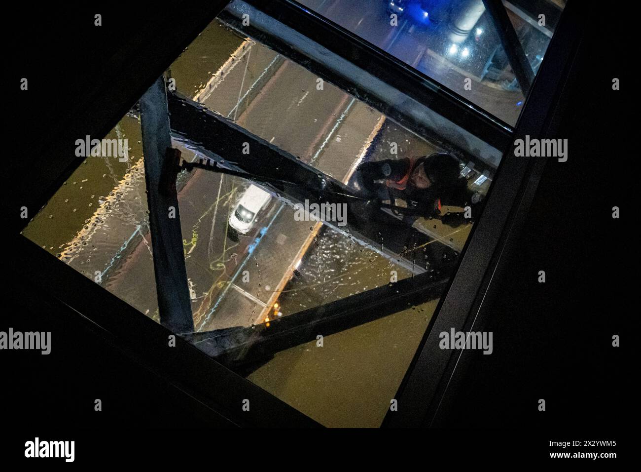 Rope access specialists hang from the underside of the walkways of ...
