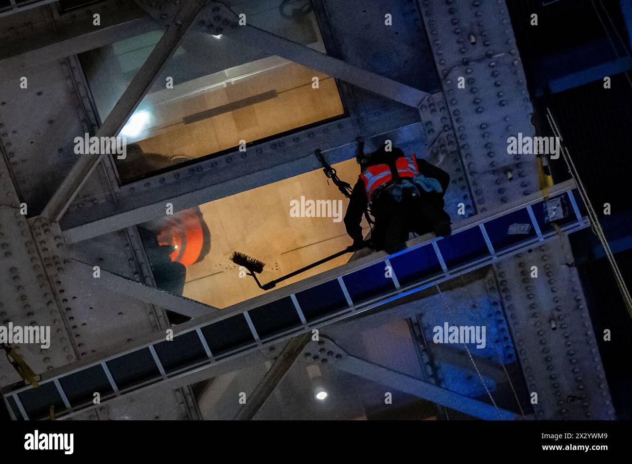 Rope access specialists hang from the underside of the walkways of ...
