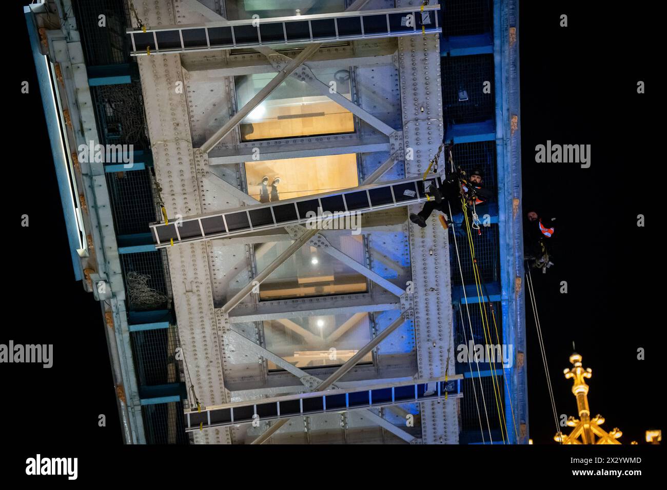 Rope access specialists hang from the underside of the walkways of ...