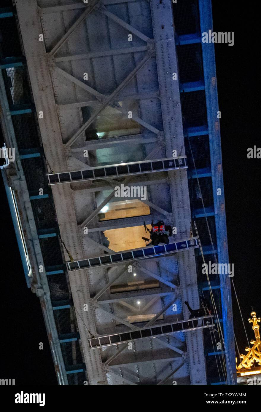 Rope access specialists hang from the underside of the walkways of ...