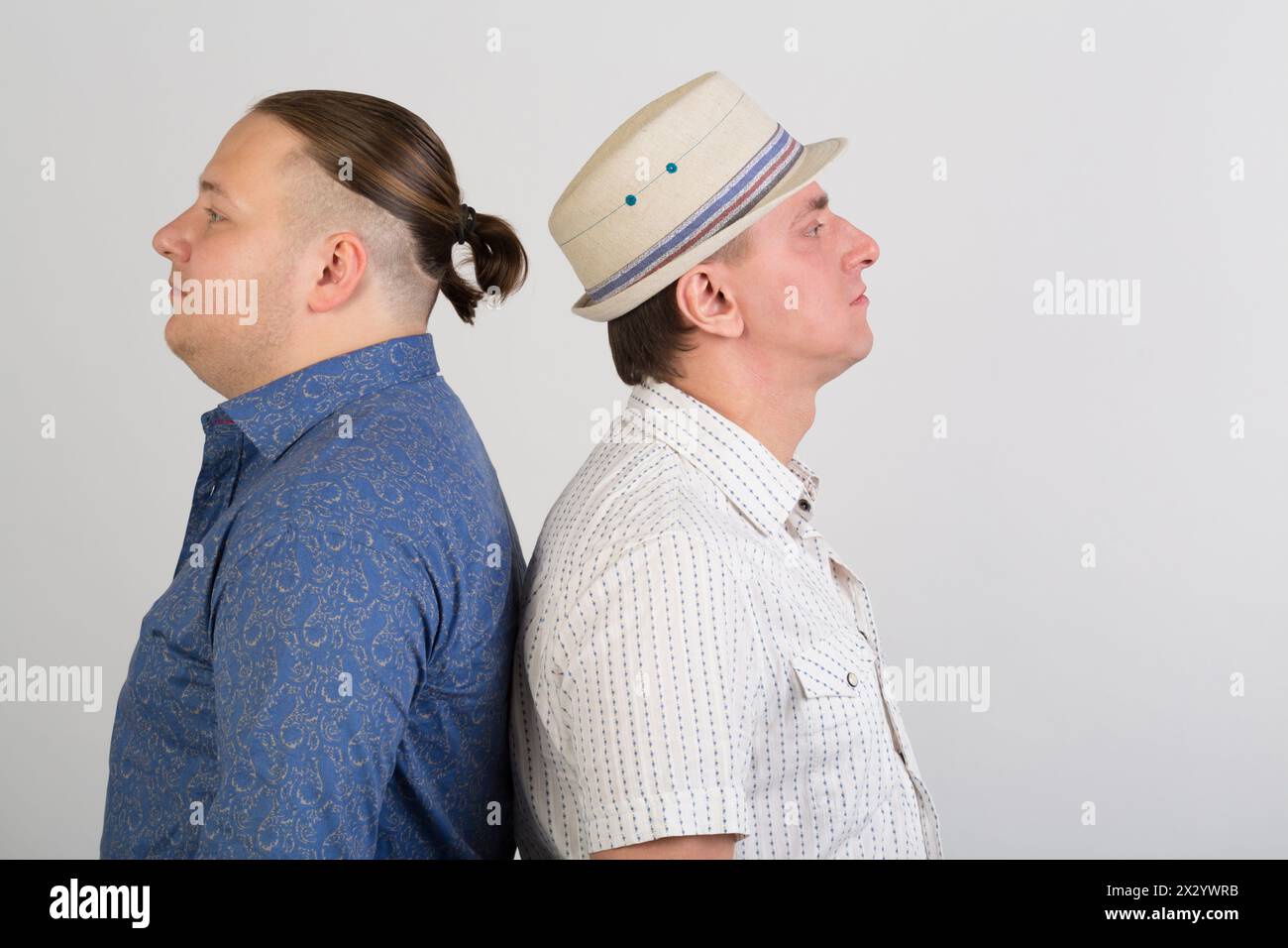 Two men standing back to back Stock Photo - Alamy