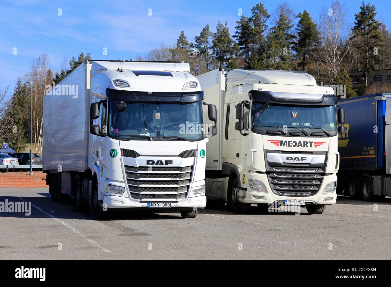 Two white DAF XF heavy trucks, 2021 generation vehicle left and ...