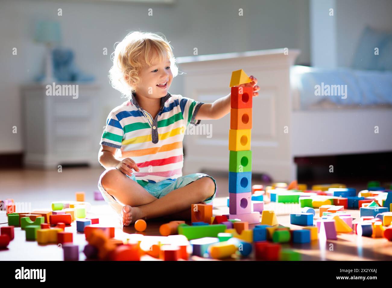Child playing with colorful toy blocks. Kids play. Little boy building ...
