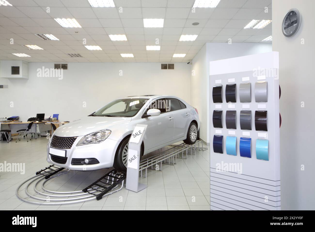 New shine car stands in office of shop selling cars near stand with ...