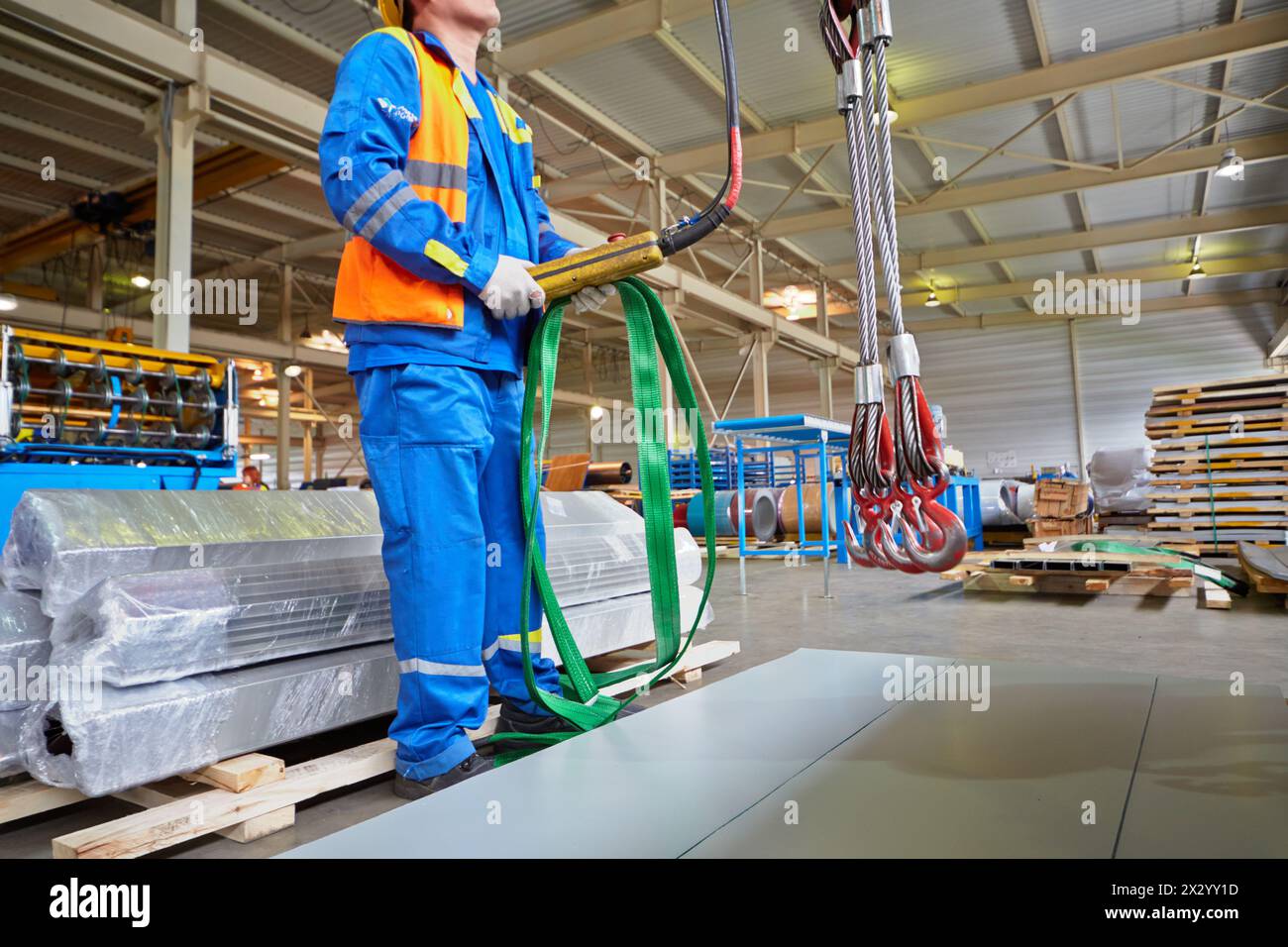 LOBNYA - JUN 7: Workers operates crane-beam in manufacturing workshop ...