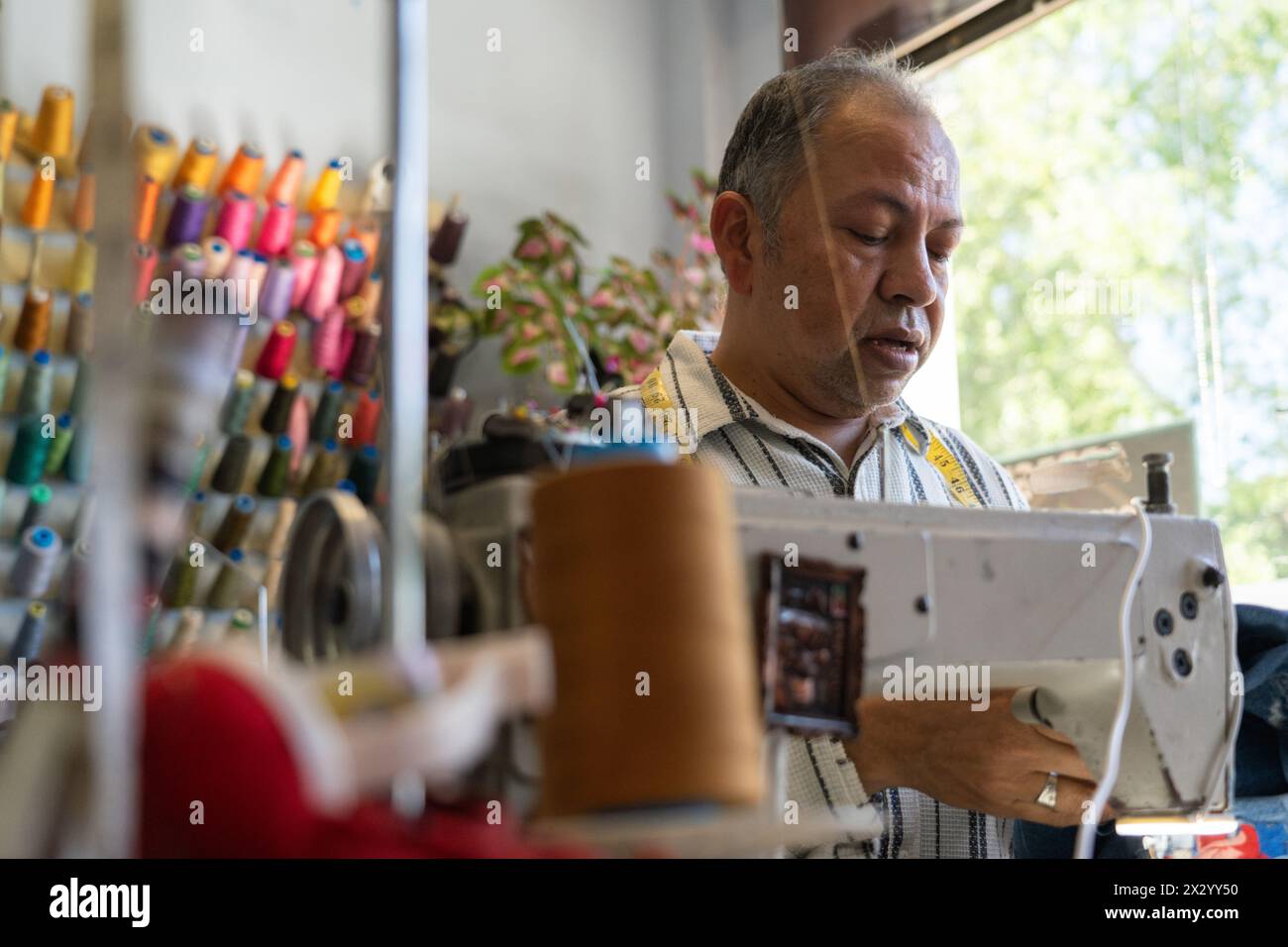 Mature latin man sewing machine hi-res stock photography and images - Alamy