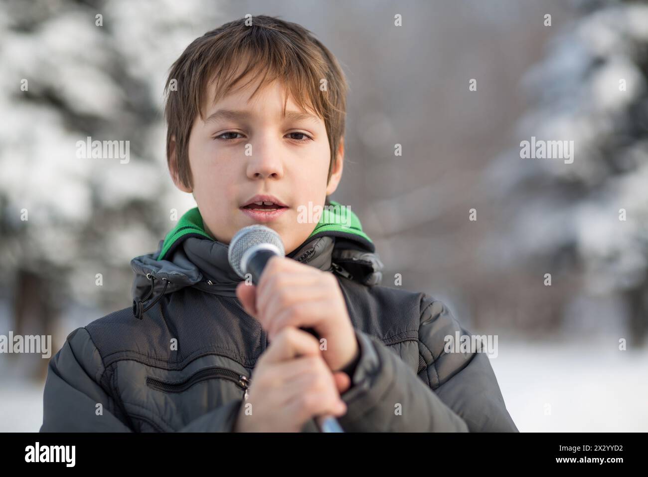 The little singer in a jacket sing outdoors in winter Stock Photo - Alamy