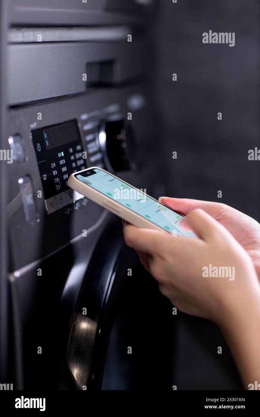Smartphone with app used to control washing machines Stock Photo - Alamy