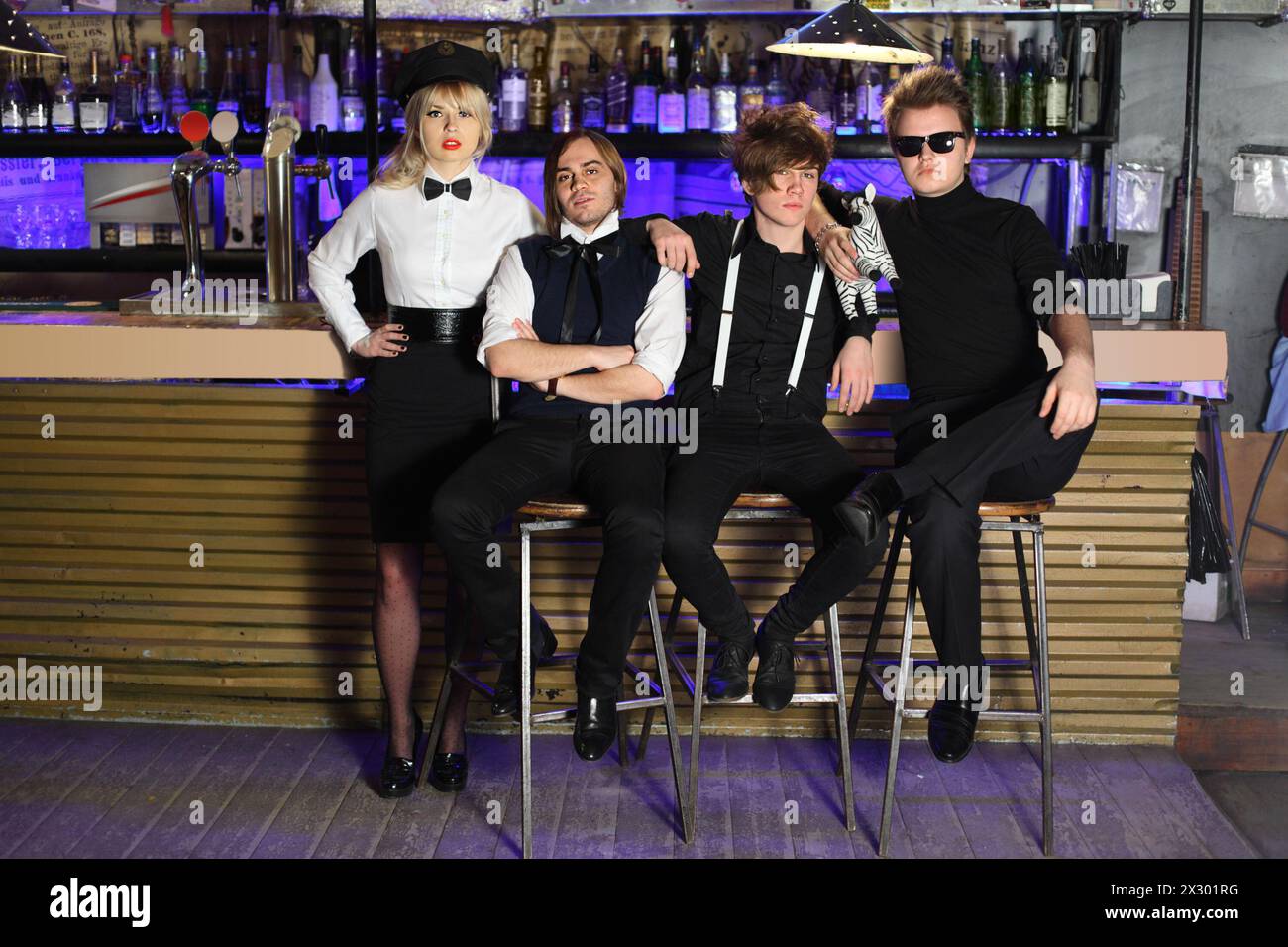 Four glamorous rock band in black and white pose near bar counter Stock ...