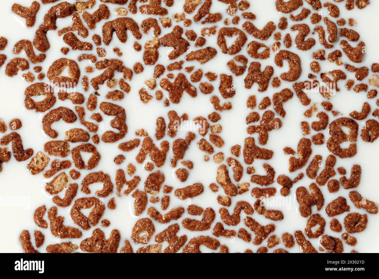 Chocolate corn flakes in the shape of letters in milk Stock Photo - Alamy