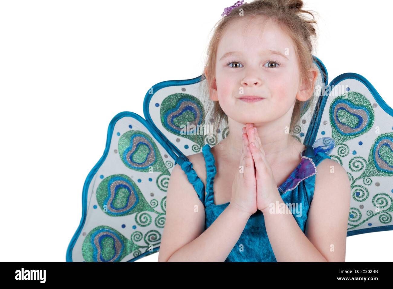 Half-length portrait of little girl in fancy dress with hands put ...