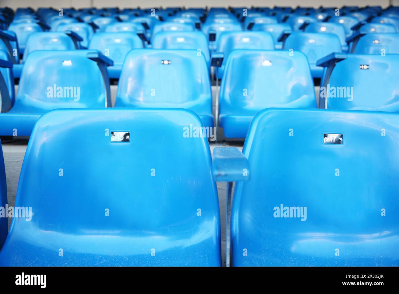 Close up of blue grandstand for fans with numbers at football stadium ...