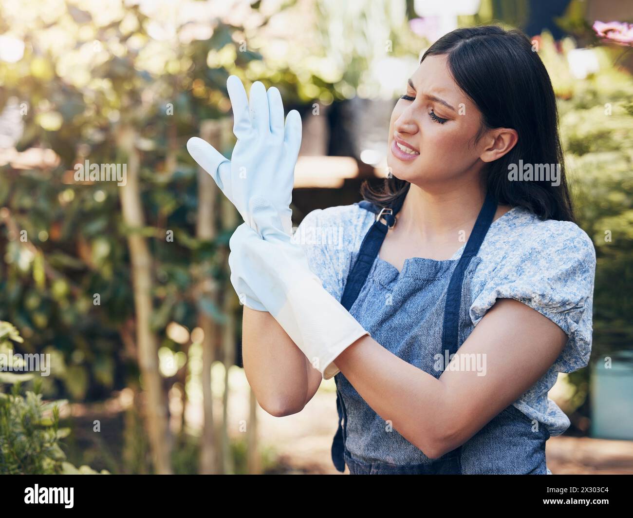 Woman, garden and gloves at work in pain with wrist, green entrepreneur ...