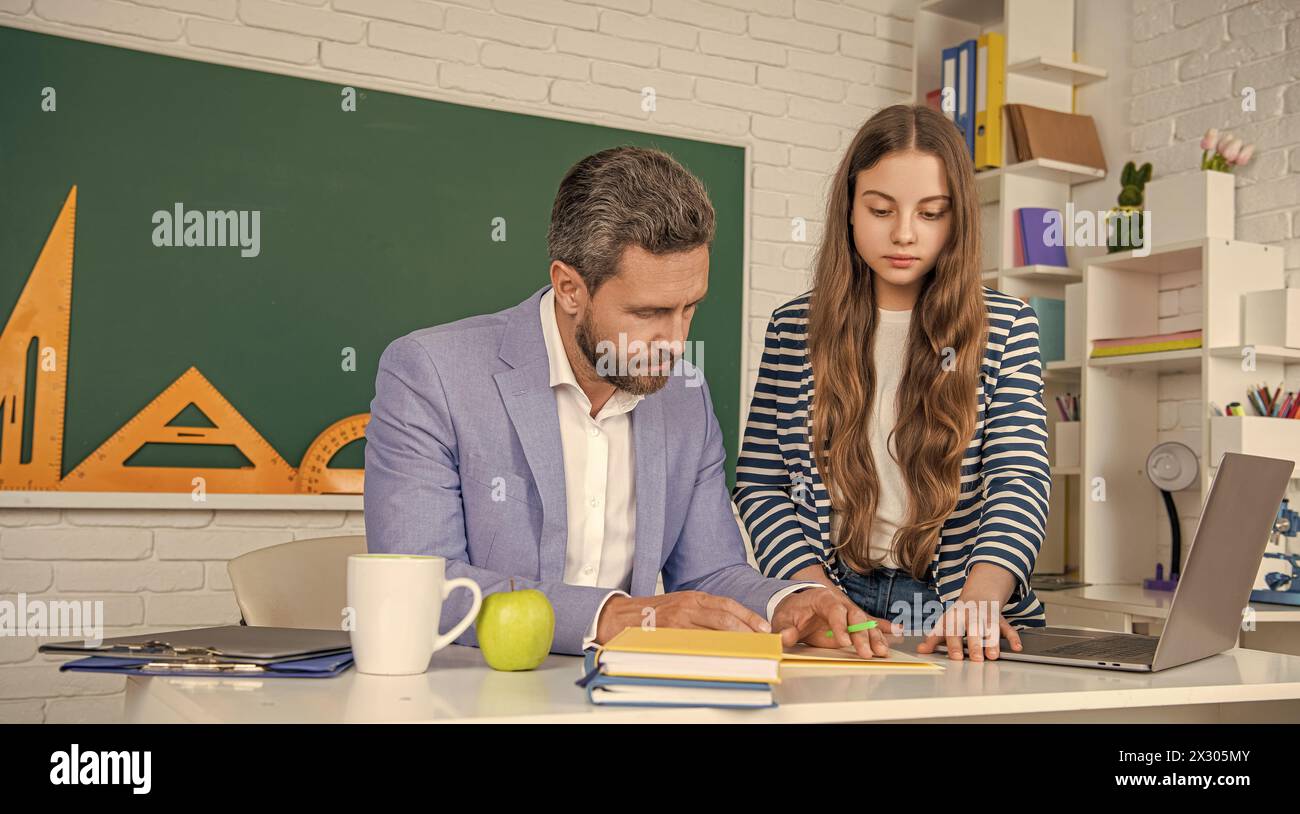 curious child study in classroom with teacher Stock Photo - Alamy