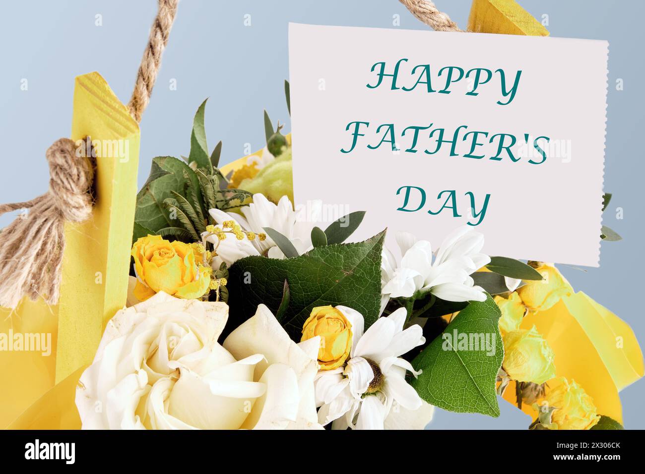 HAPPY FATHER'S DAY text on a business card in a bouquet of flowers ...