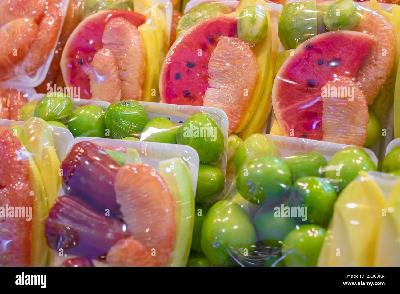 Colorful Fruits. Fruits wrapped in plastic on sale. Exotic fruits on ...