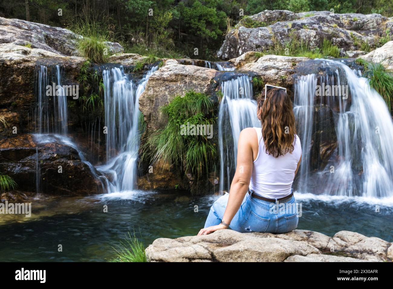 Rear view woman looking waterfall hi-res stock photography and images ...