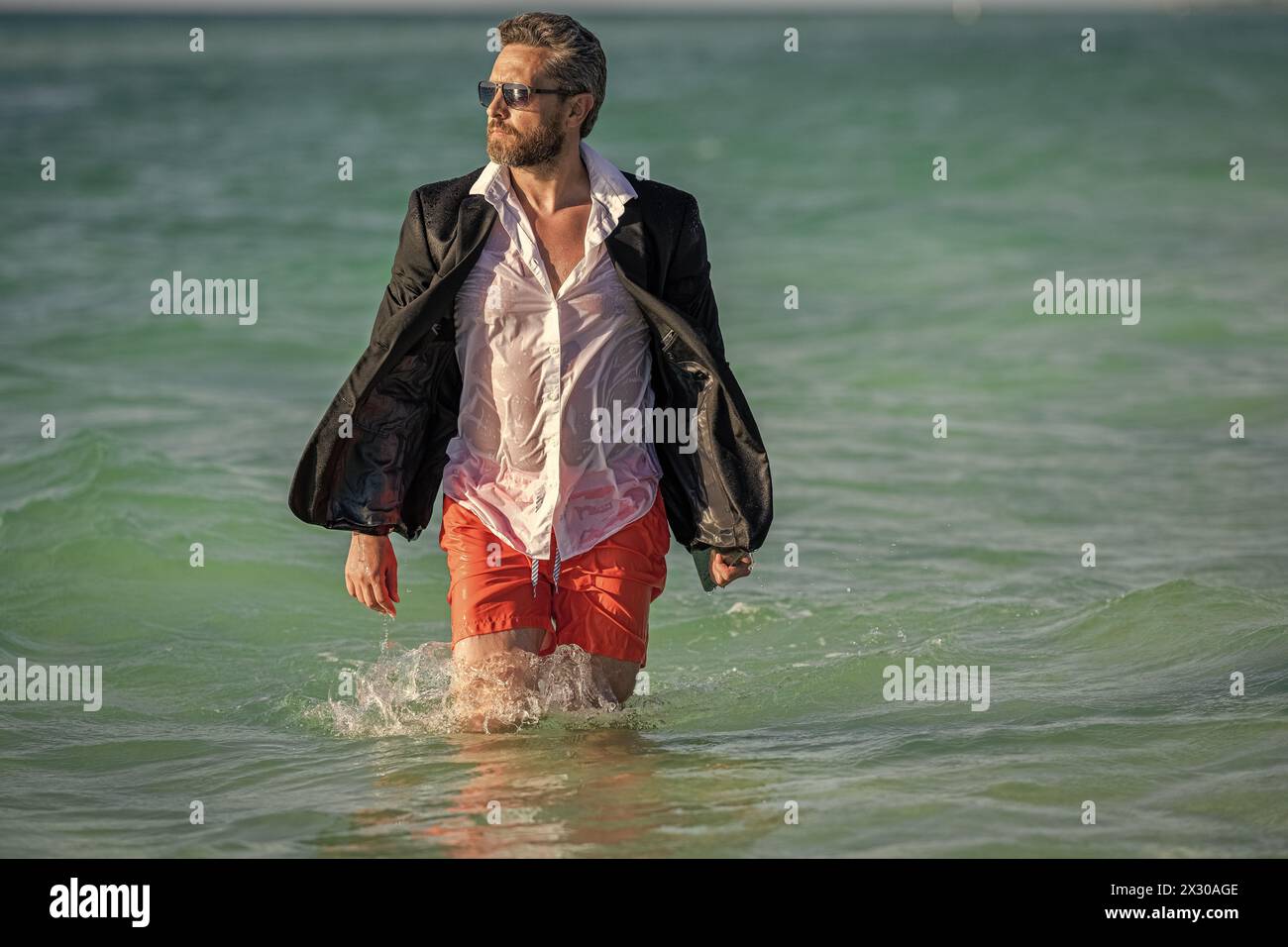 businessman with laptop in formal wear near tropical beach. Hot ...