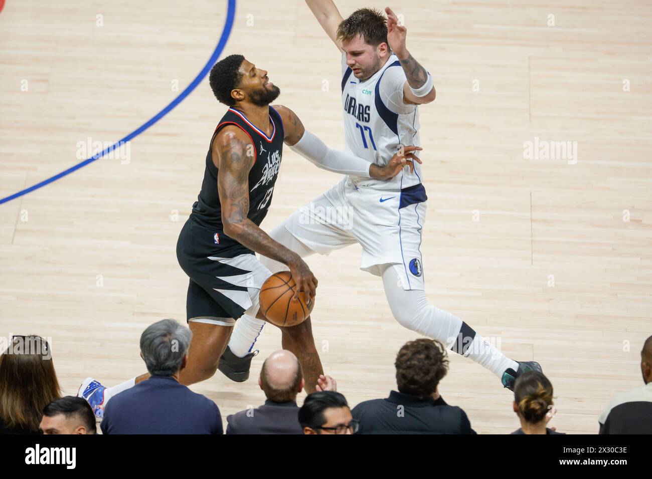 Los Angeles, USA. 23rd Apr, 2024. Los Angeles Clippers' Paul George (L) drives against Dallas ...