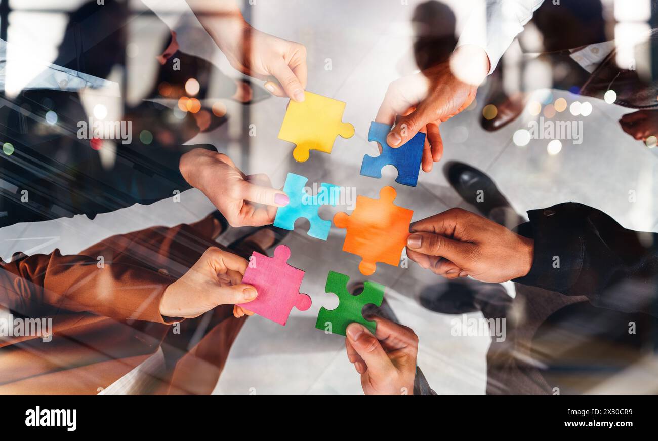 Businessmen working together to build a puzzle as teamwork, partnership ...