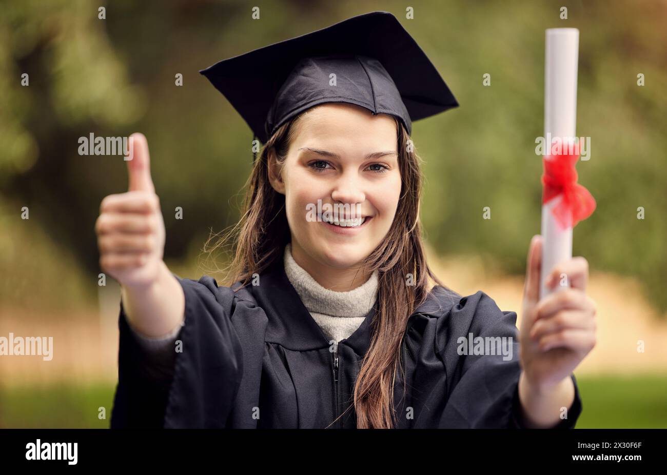 Graduation, thumbs up and portrait of woman at university for education ...