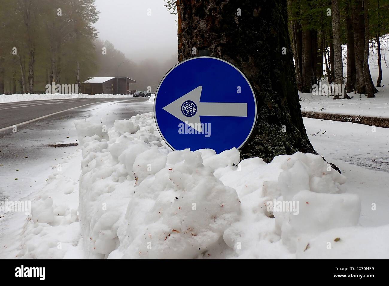 Road sign covered by snow. On April 21st, heavy snowfall covered Bocca ...