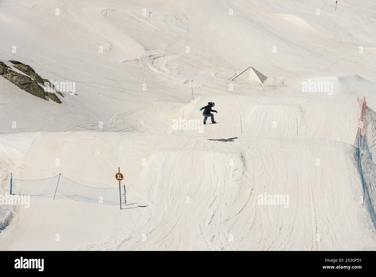 Snow park tricks in mountains. Snow park pipe tricks. Snowboarder in ...