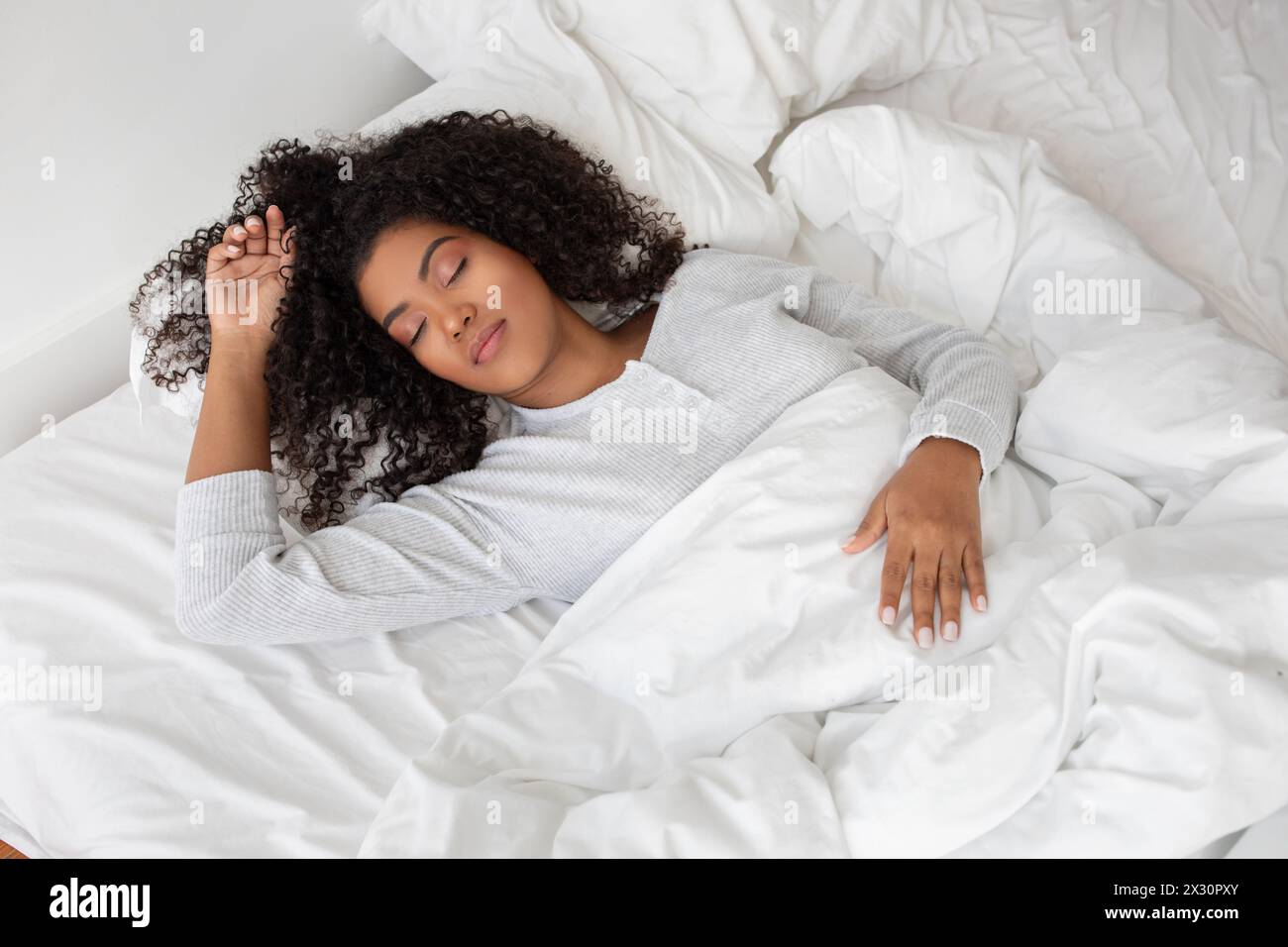 Woman Laying in Bed With White Sheets Stock Photo - Alamy