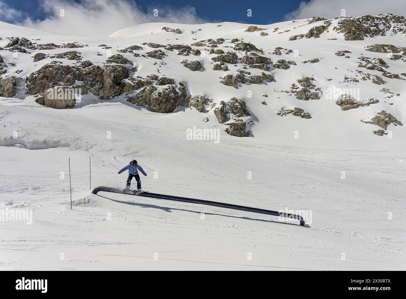 Snow park tricks in mountains. Snow park pipe tricks. Snowboarder in ...