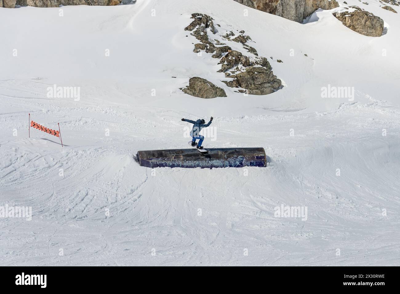 Snow park tricks in mountains. Snow park pipe tricks. Snowboarder in ...