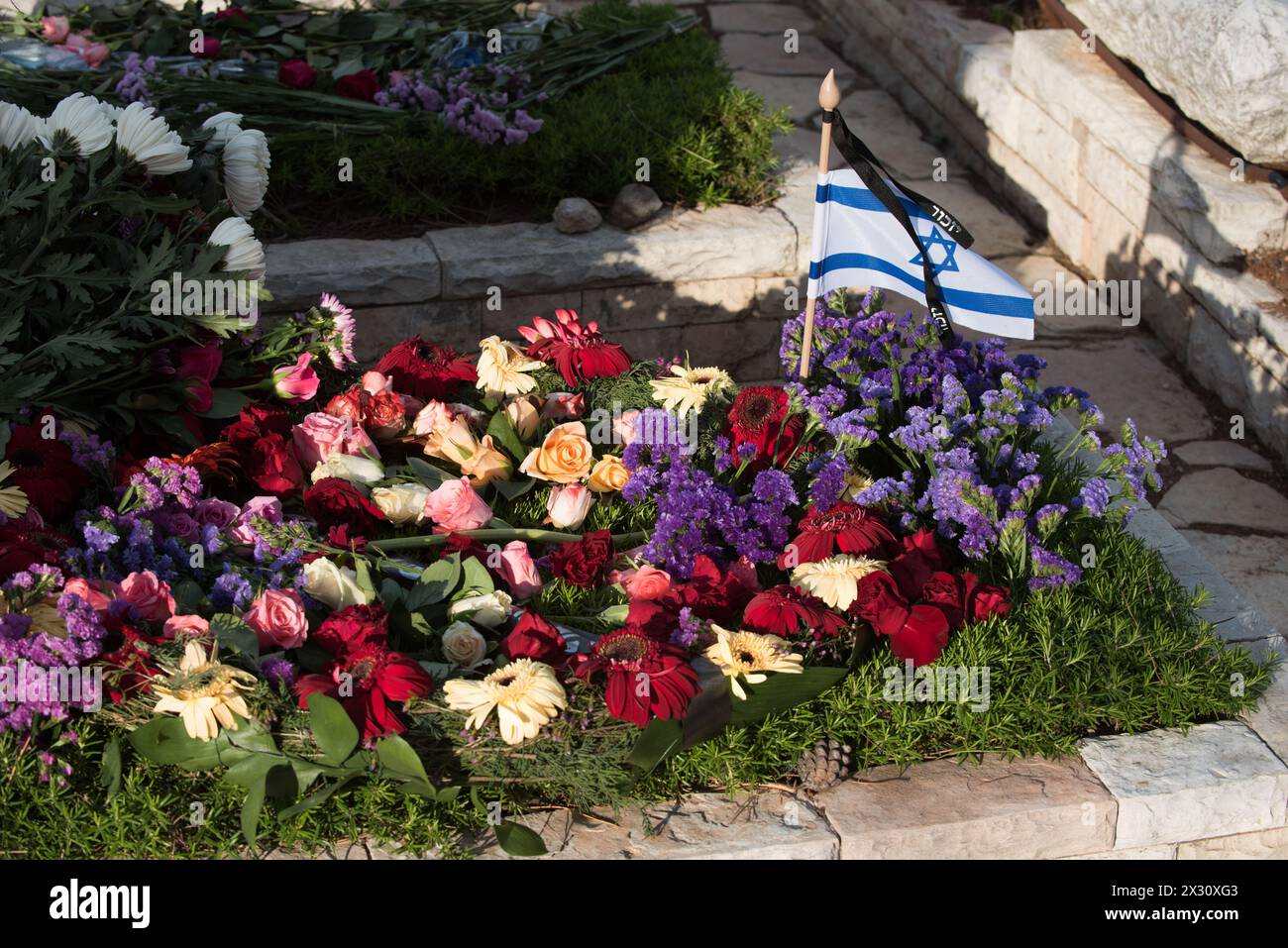 Flowers are laid on the grave of a fallen soldier in Jerusalem's Har ...