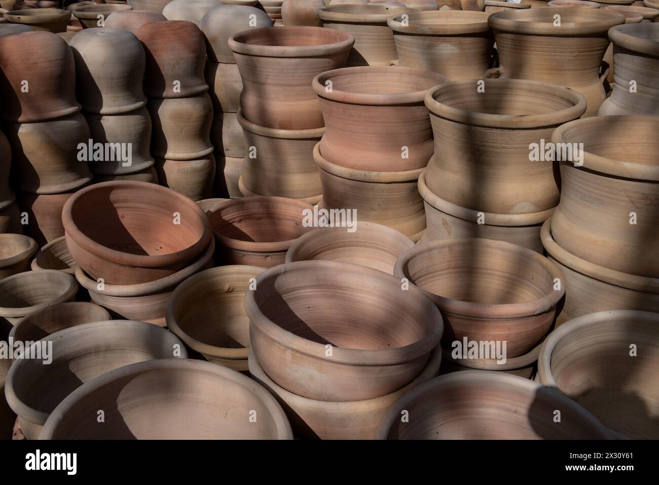 Variety of earth-tone, empty, clay pots in a mix of shapes and sizes ...