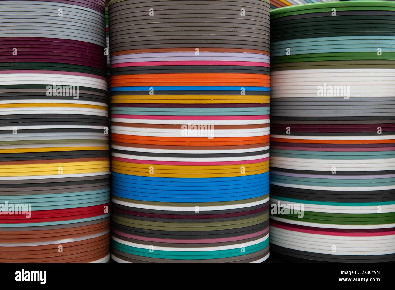 Multi-colored plastic plant containers stacked tightly in rows to form ...